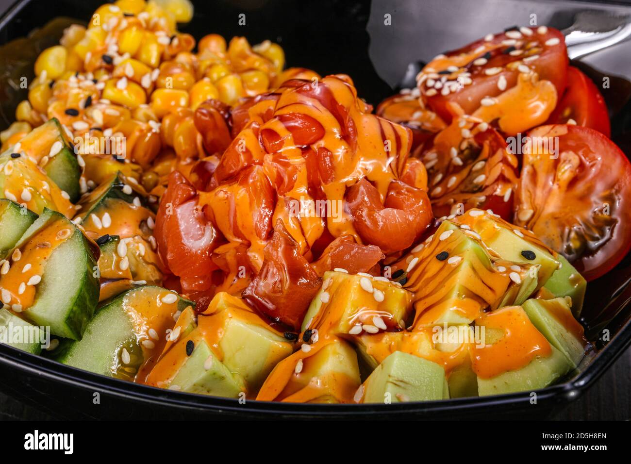 Hawaian cuisine - Poke with Salmon and rice Stock Photo - Alamy