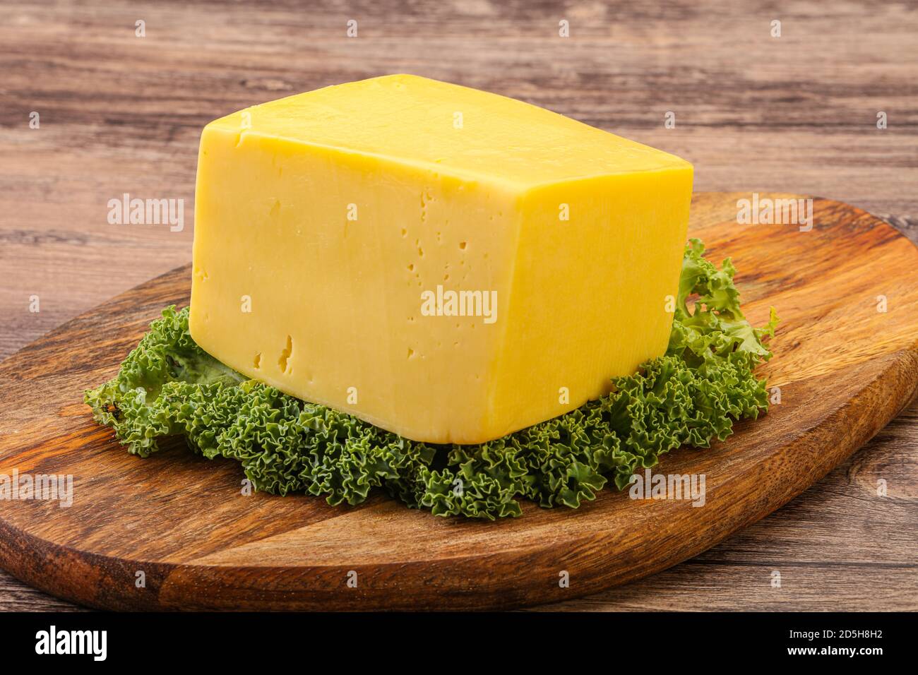 Yellow tilsiter cheese dairy product brick Stock Photo - Alamy