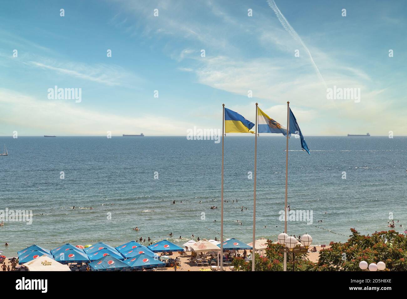 CHORNOMORSK, UKRAINE - AUGUST 08, 2020: People have a rest on sandy ...