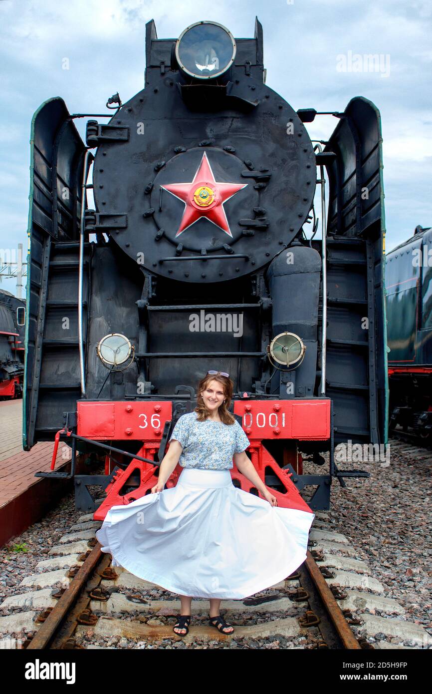 Young woman with billowing dress against the background of steam ...