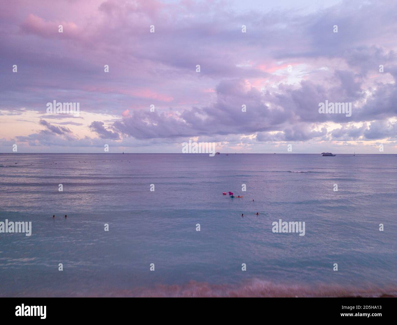 Breathtaking view of the wavy ocean gleaming under the cloudy sky ...