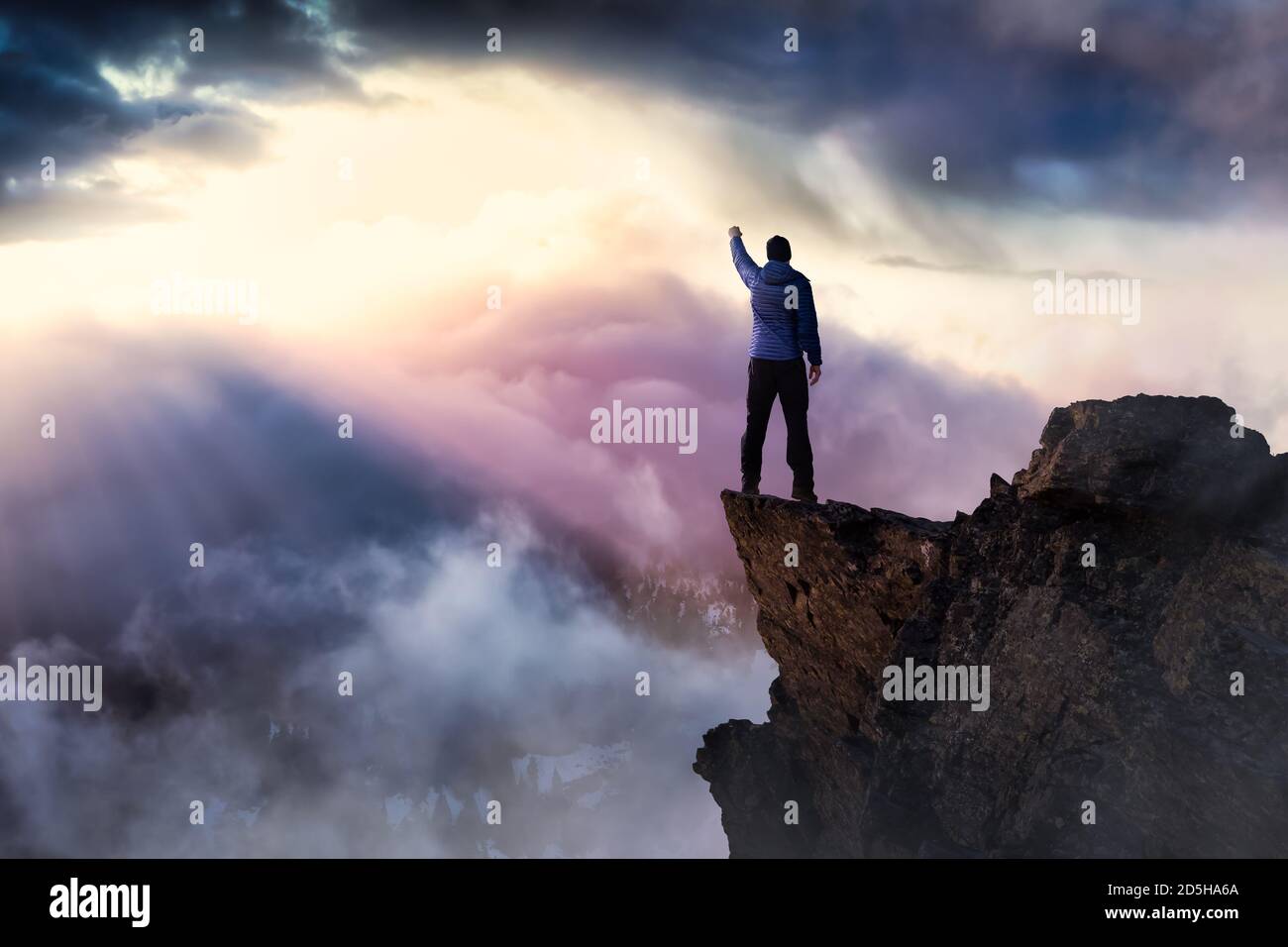 Fantasy Adventure Composite with a Man on top of a Mountain Cliff Stock ...