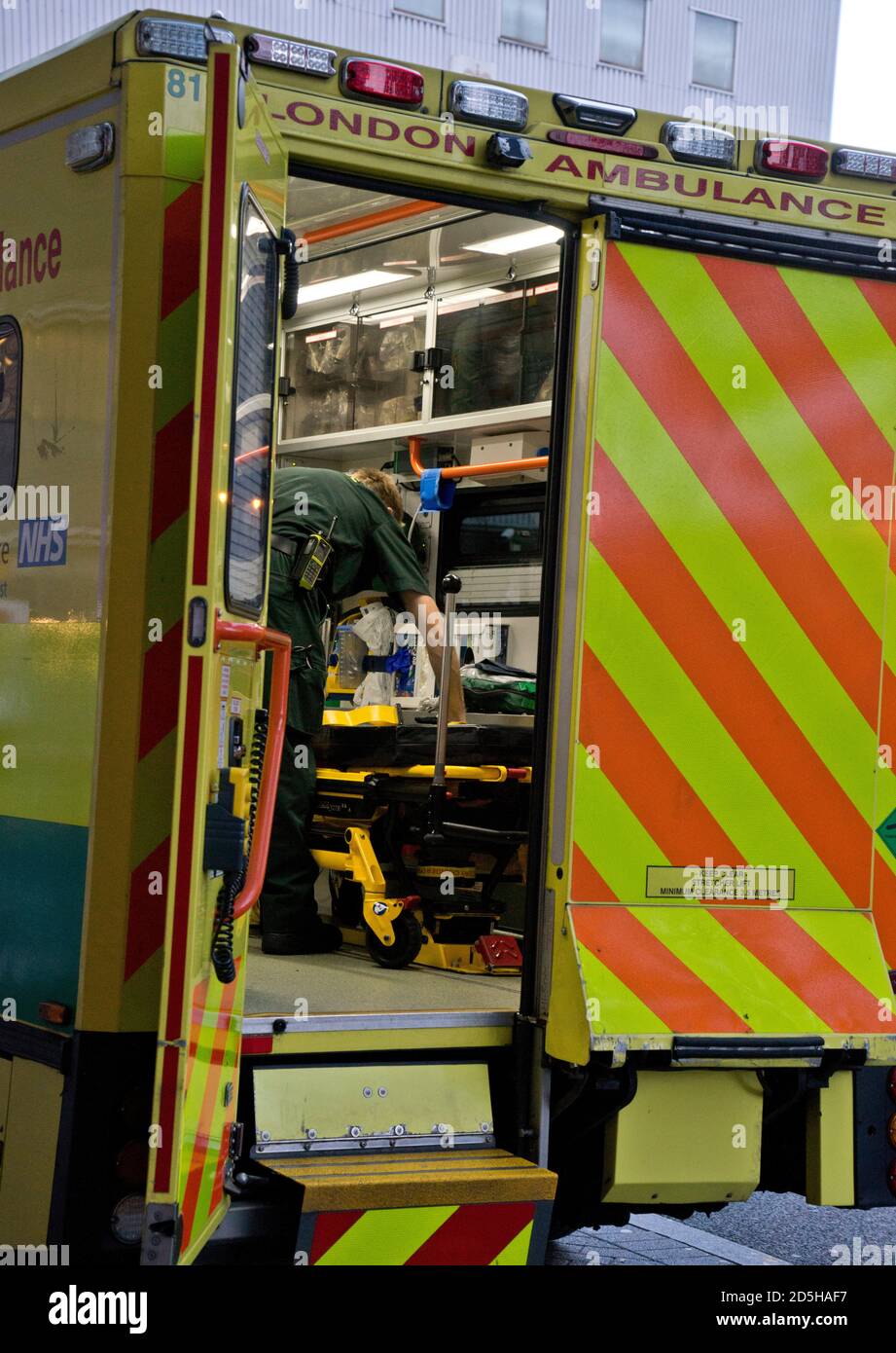 Ambulance worker cleaning the vehicle after transporting patients with ...
