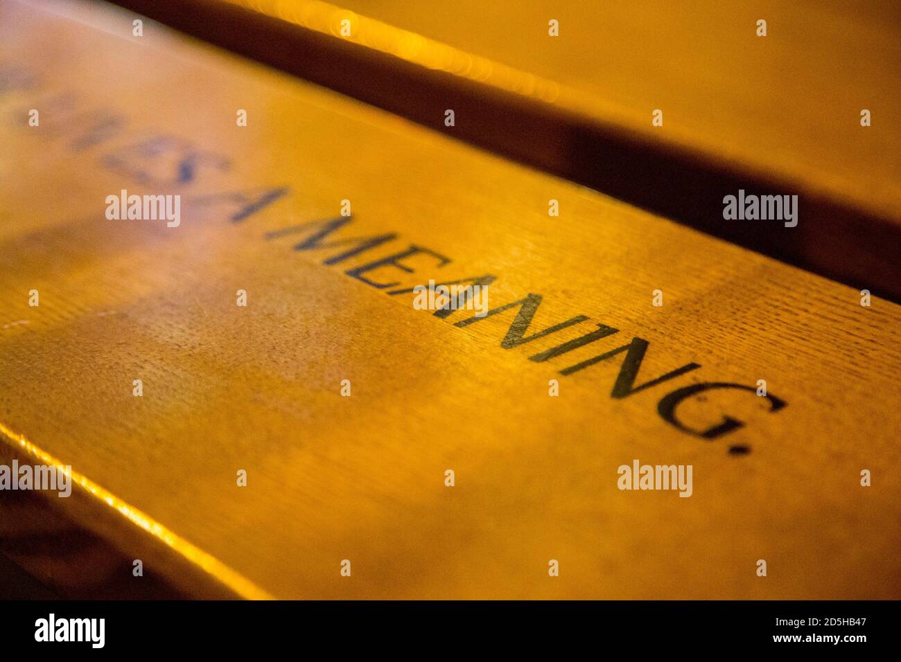 Quote on a bench that says the word "Meaning Stock Photo - Alamy