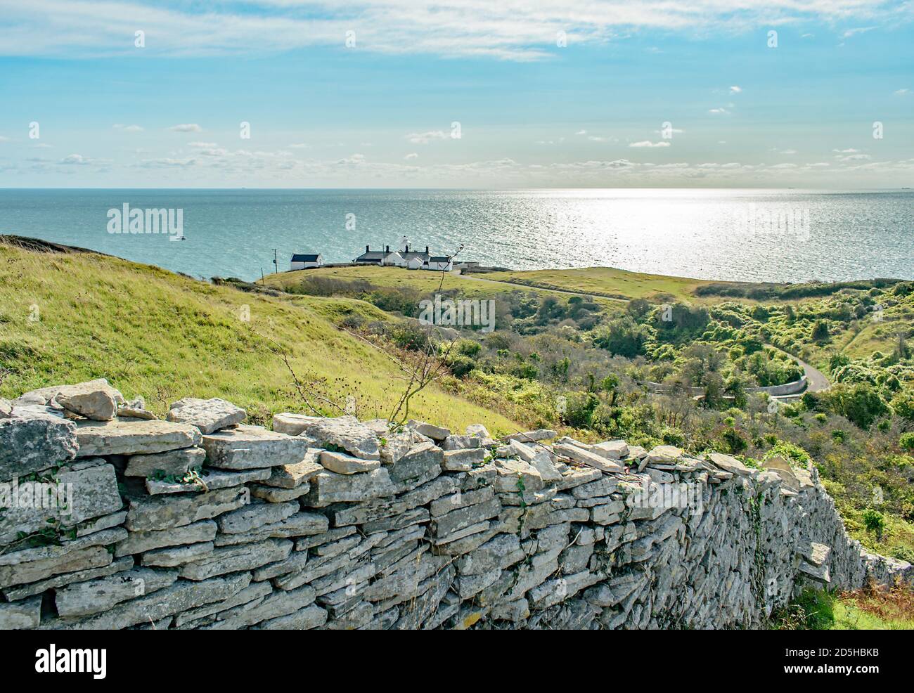 A view along the dry stone wall looking down over Anvil Point ...