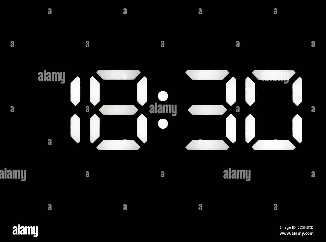 Real white led digital clock on a black background showing time 18:30 Stock Photo - Alamy
