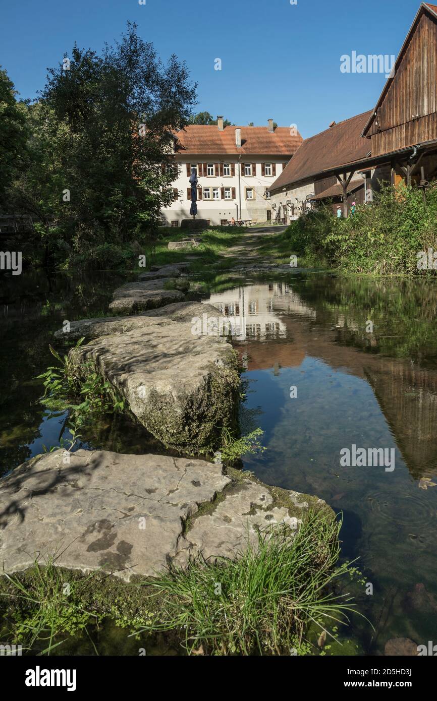 little river with a historic mill building Stock Photo - Alamy