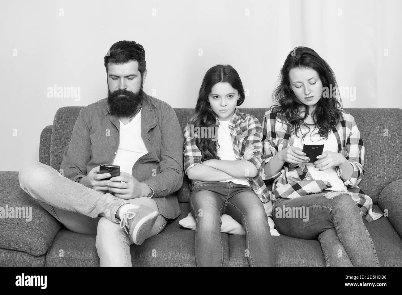 Ignored child. Busy parents surfing internet smartphones. Dad and mom ...
