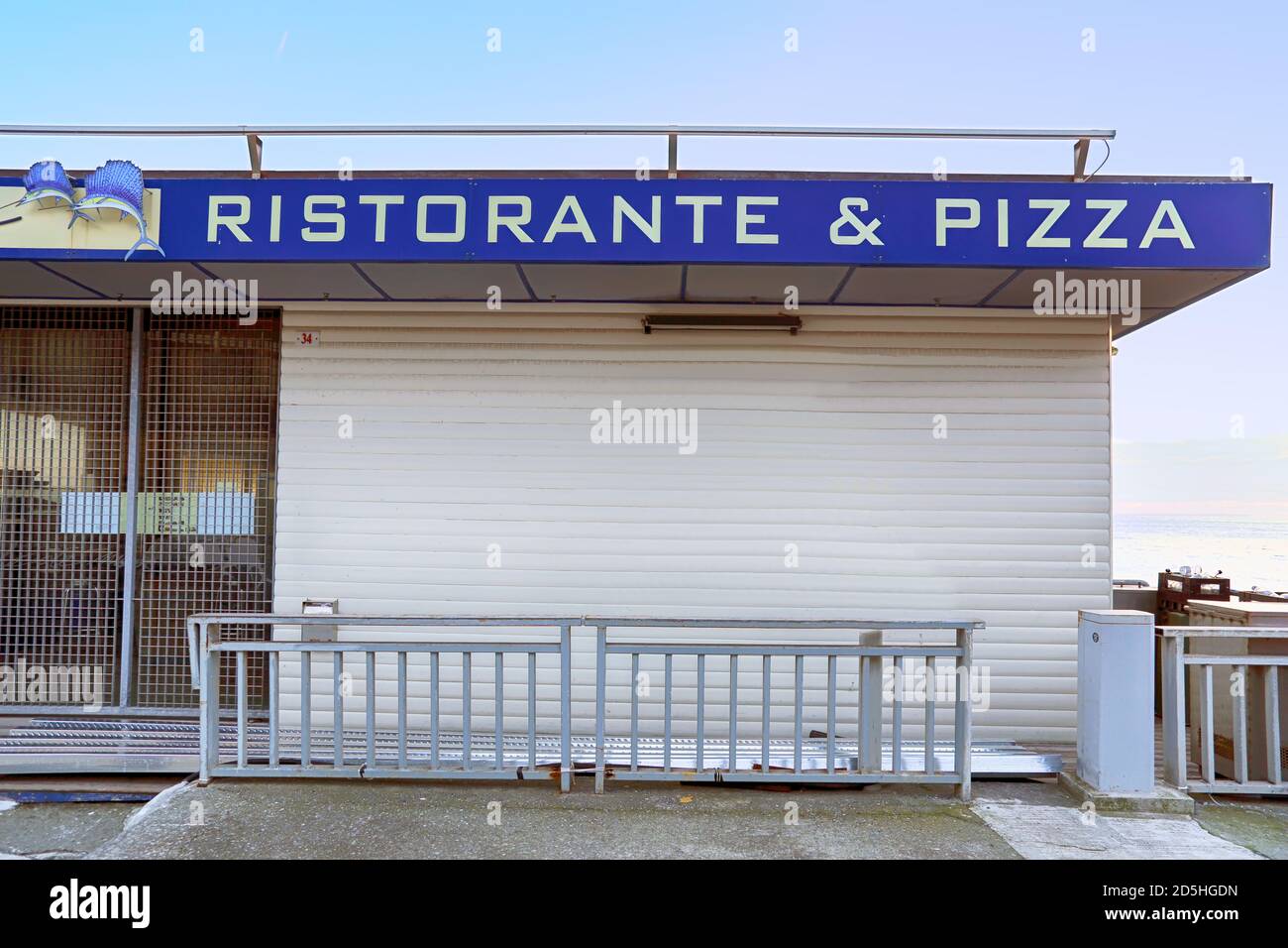 Liguria,Italy. Front view of a Restaurant Pizzeria with portcullis ...