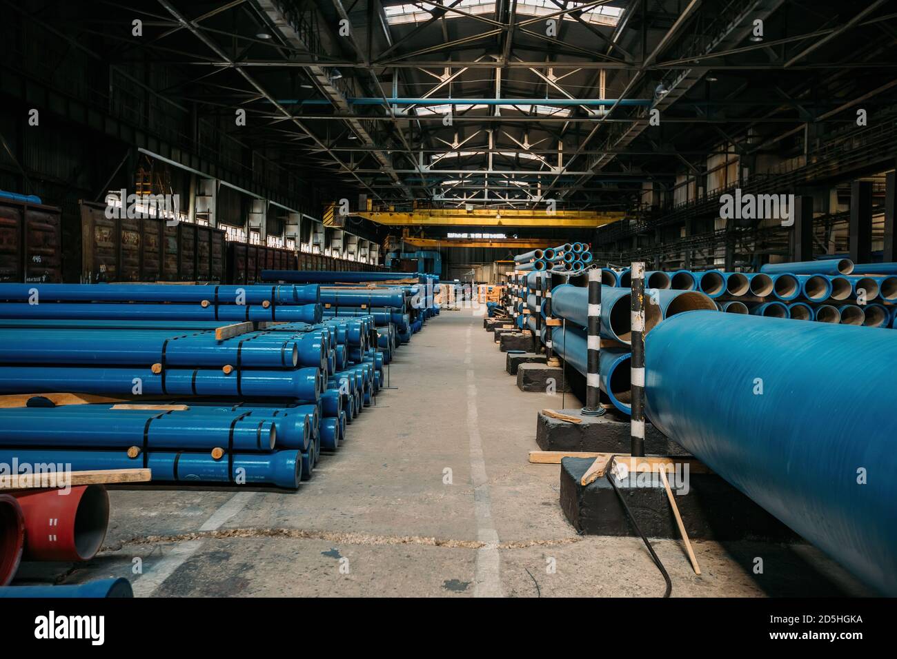 New cast iron pipes for pipeline construction in warehouse Stock Photo ...