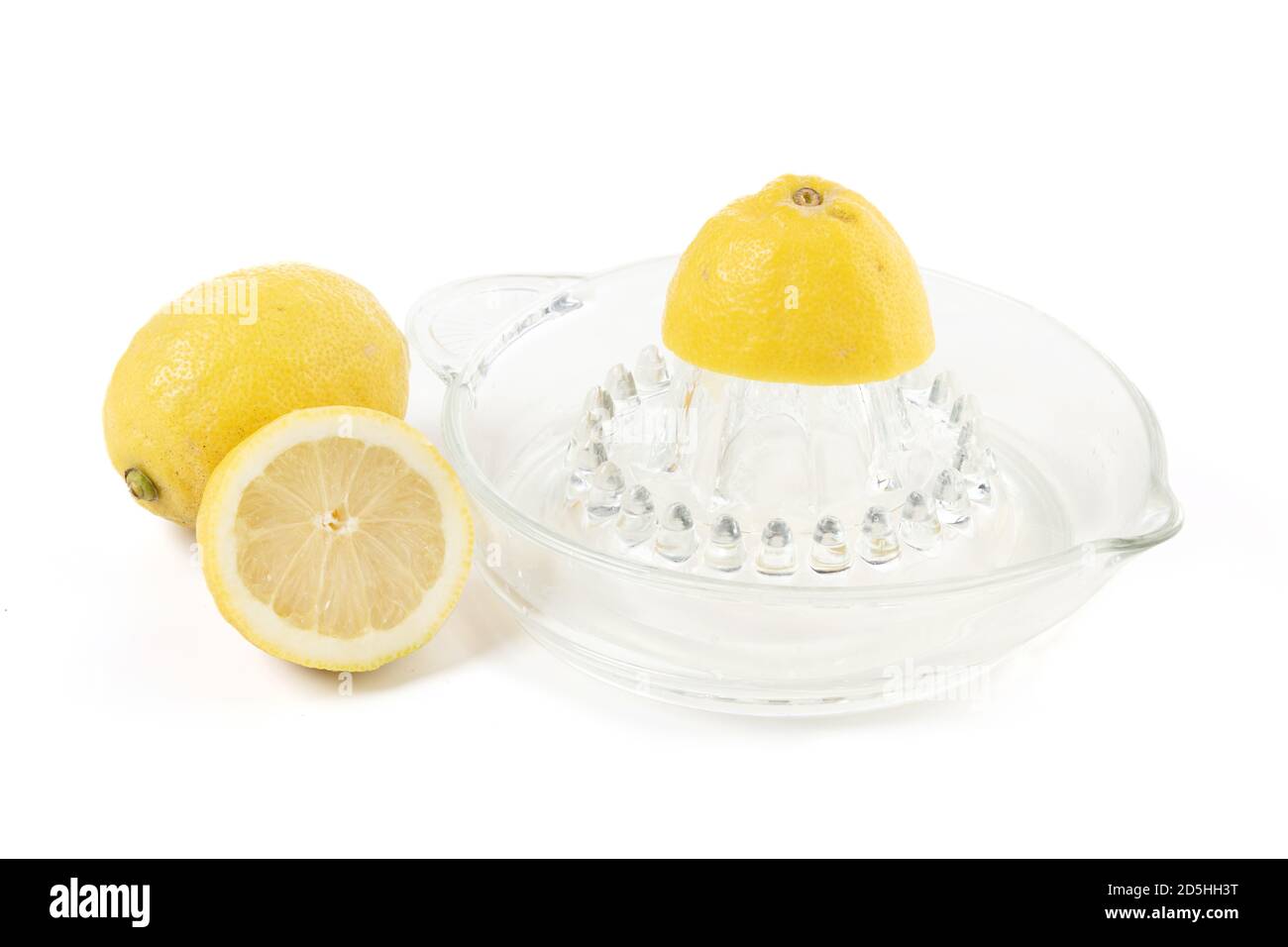 Lemon and lemon squeezer in glass on a white background Stock Photo - Alamy