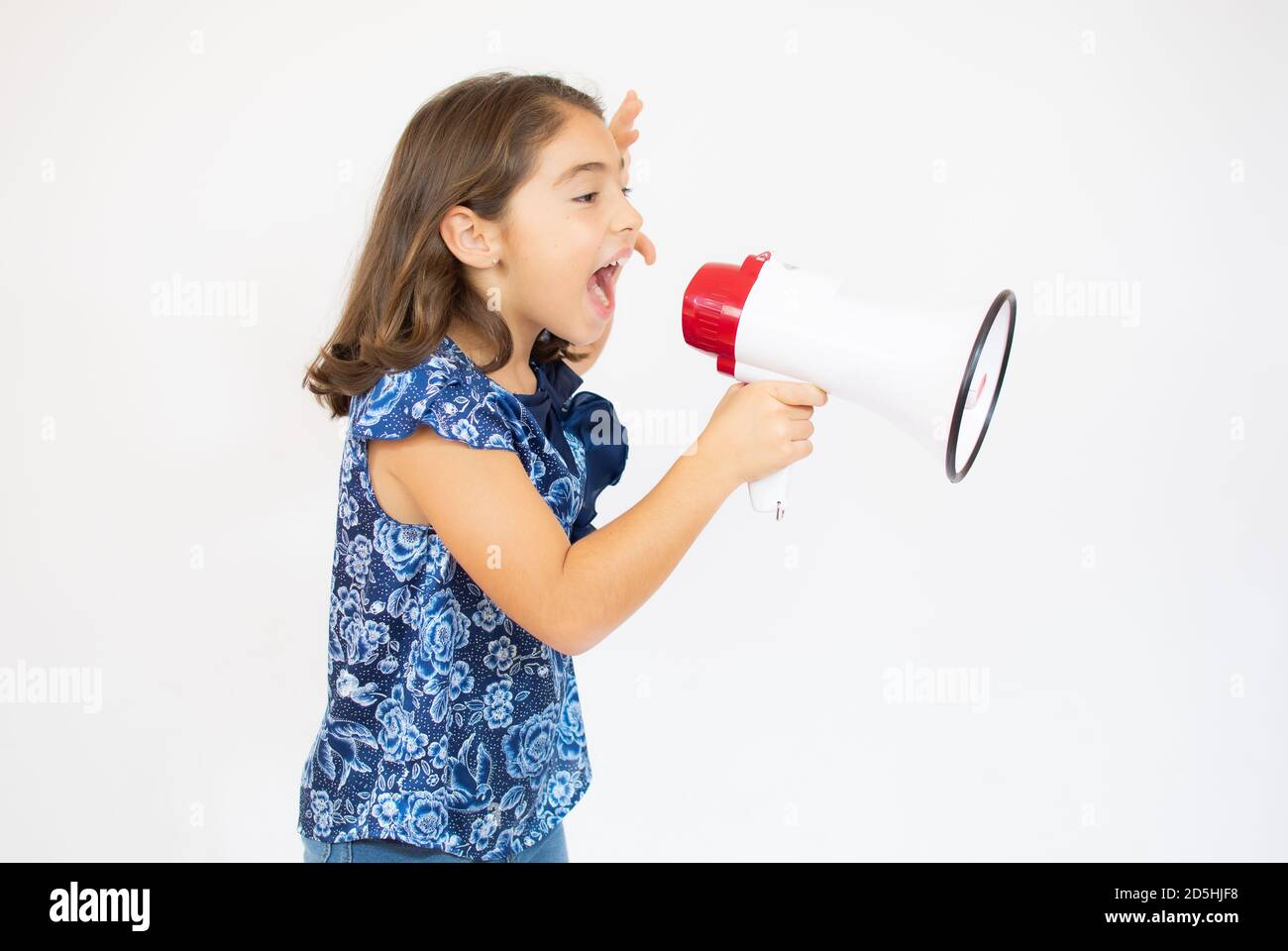 Little girl screaming and shouting with megaphone Stock Photo - Alamy