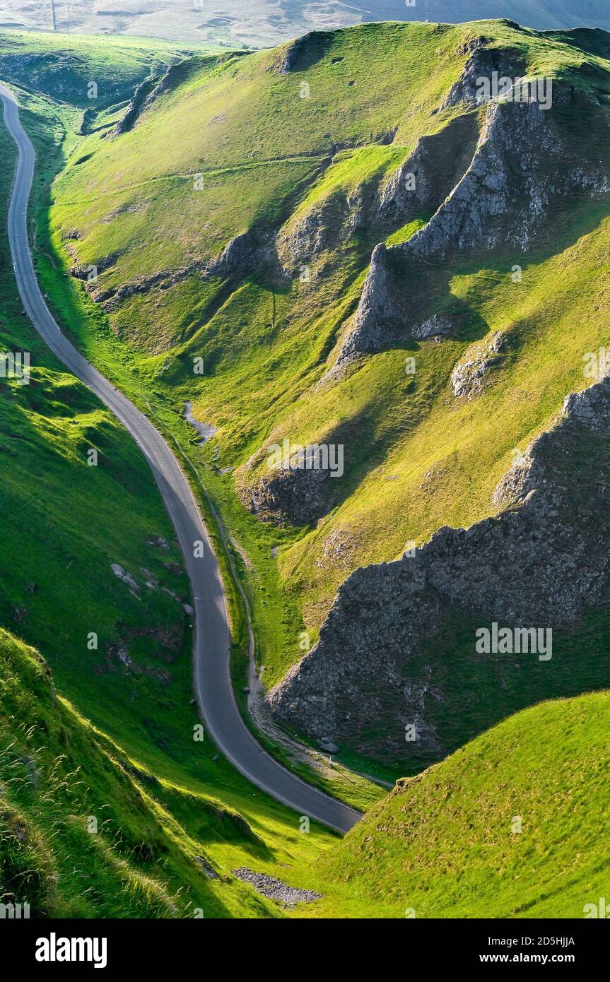 The winding road in the deep gorge of reef limestone at Winnats Pass ...