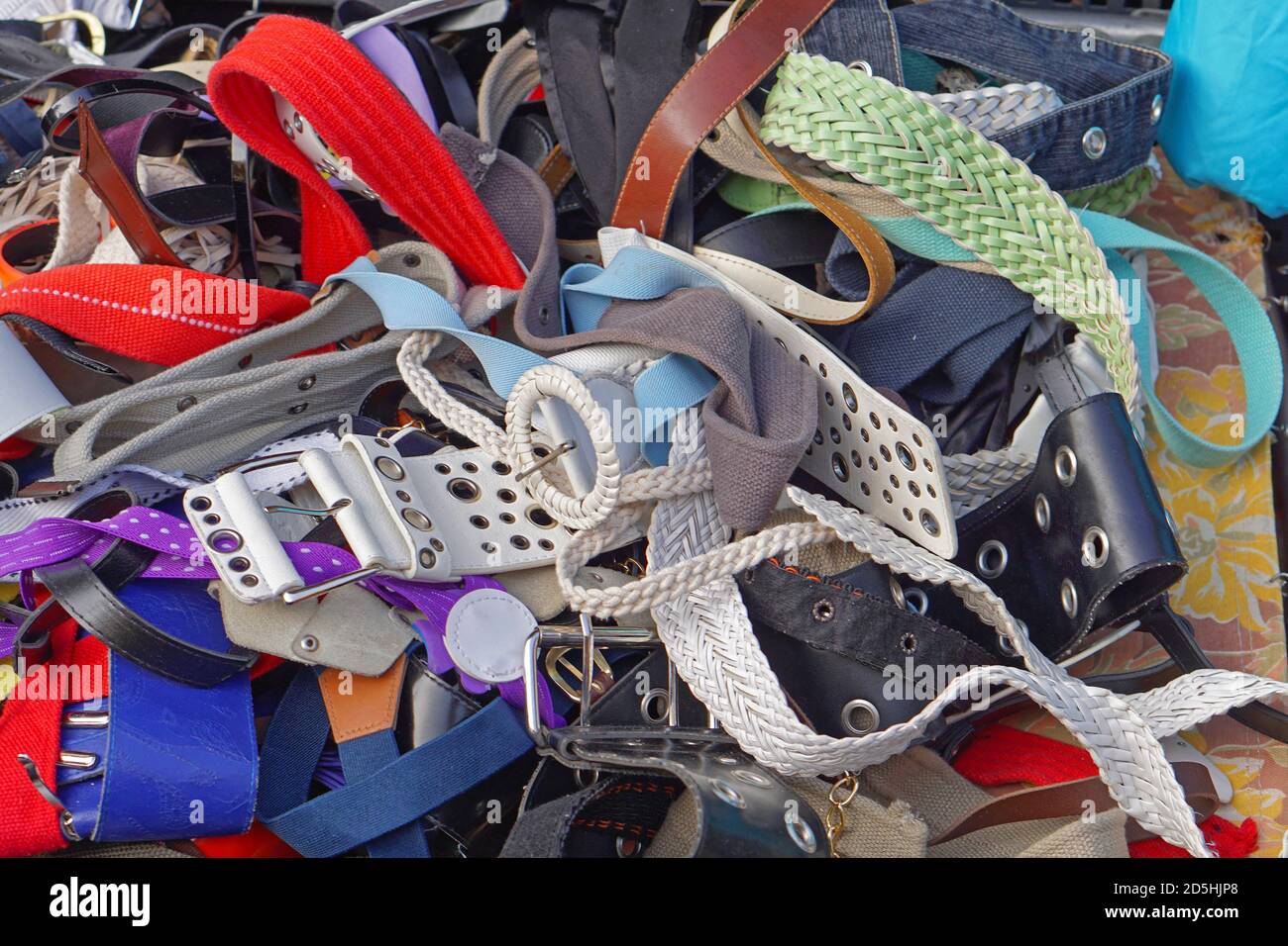 Bunch of used belts at flea market Stock Photo - Alamy