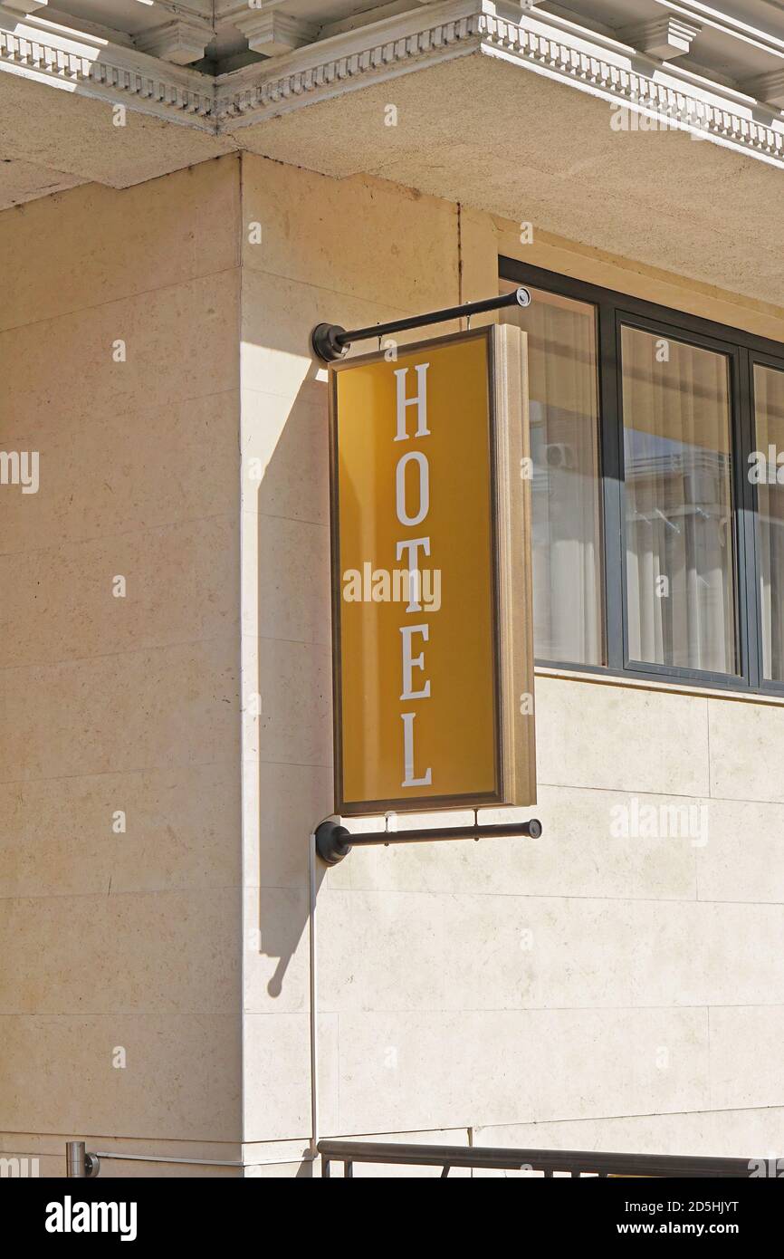 Vertical gold sign at hotel building sunny day Stock Photo - Alamy
