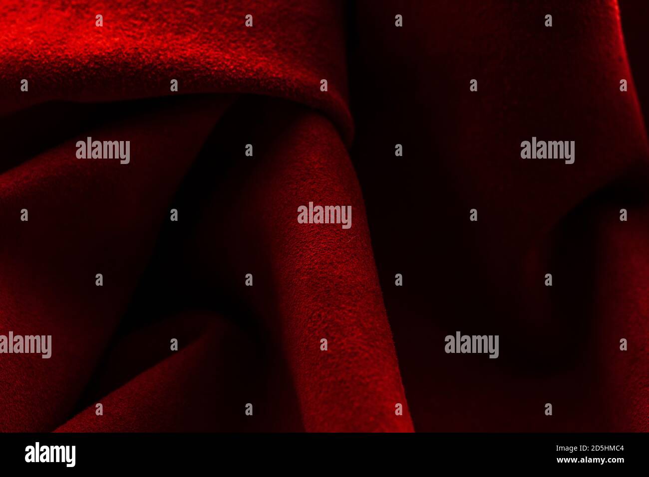 Red matte background of suede fabric, closeup. Velvet texture of ...