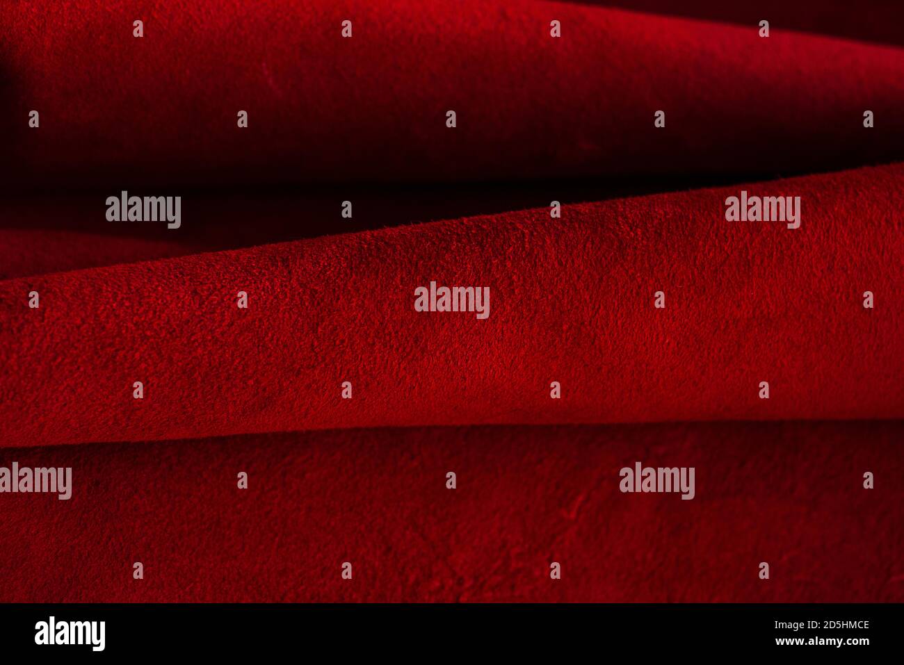 Red matte background of suede fabric, closeup. Velvet texture of ...