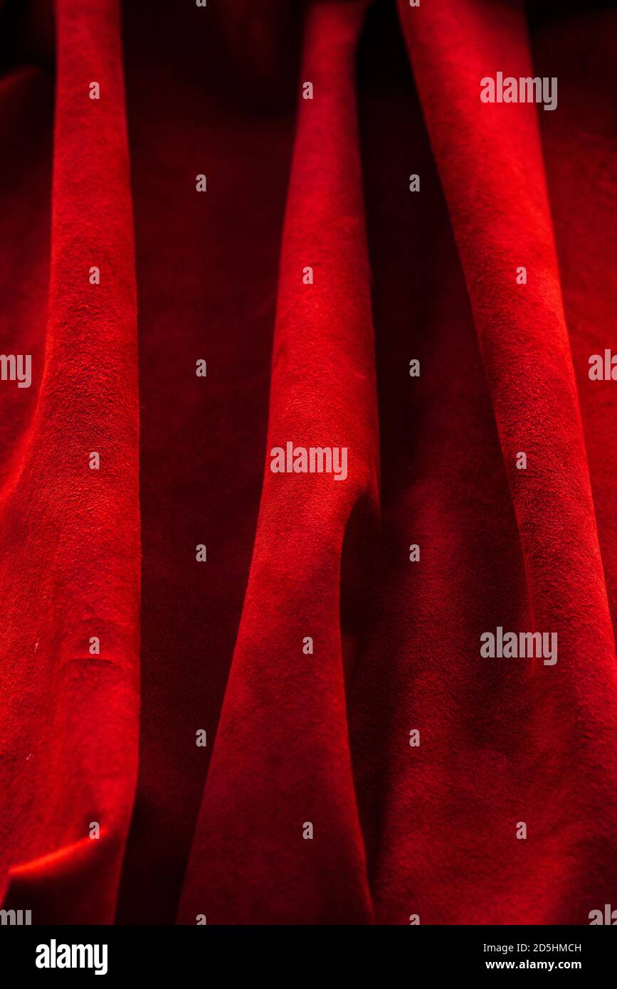 Red matte background of suede fabric, closeup. Velvet texture of ...