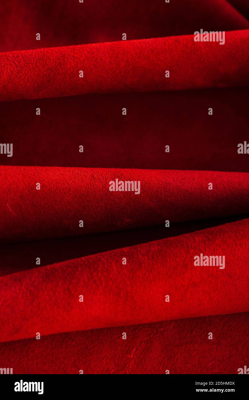 Red matte background of suede fabric, closeup. Velvet texture of ...