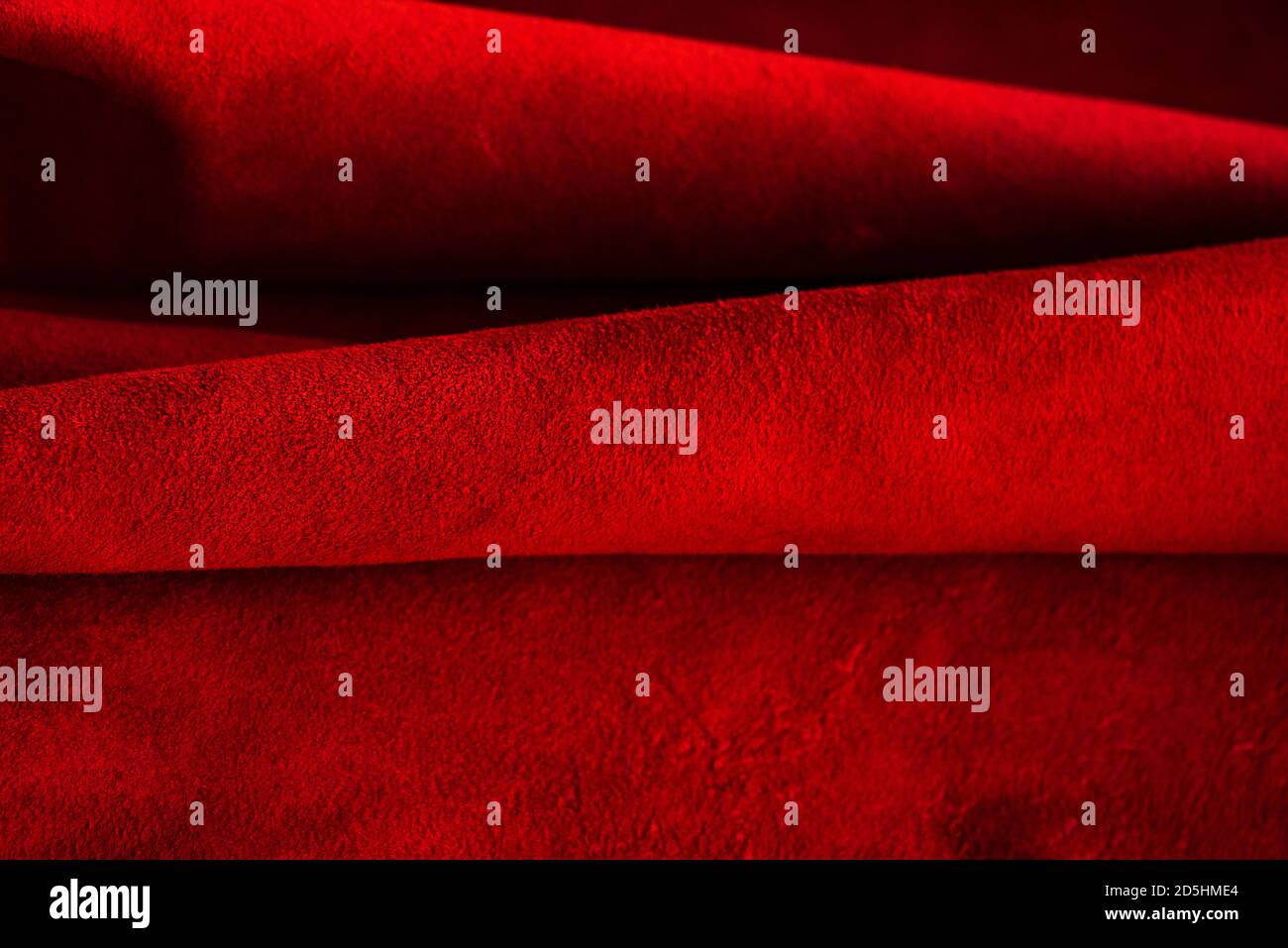 Red matte background of suede fabric, closeup. Velvet texture of ...