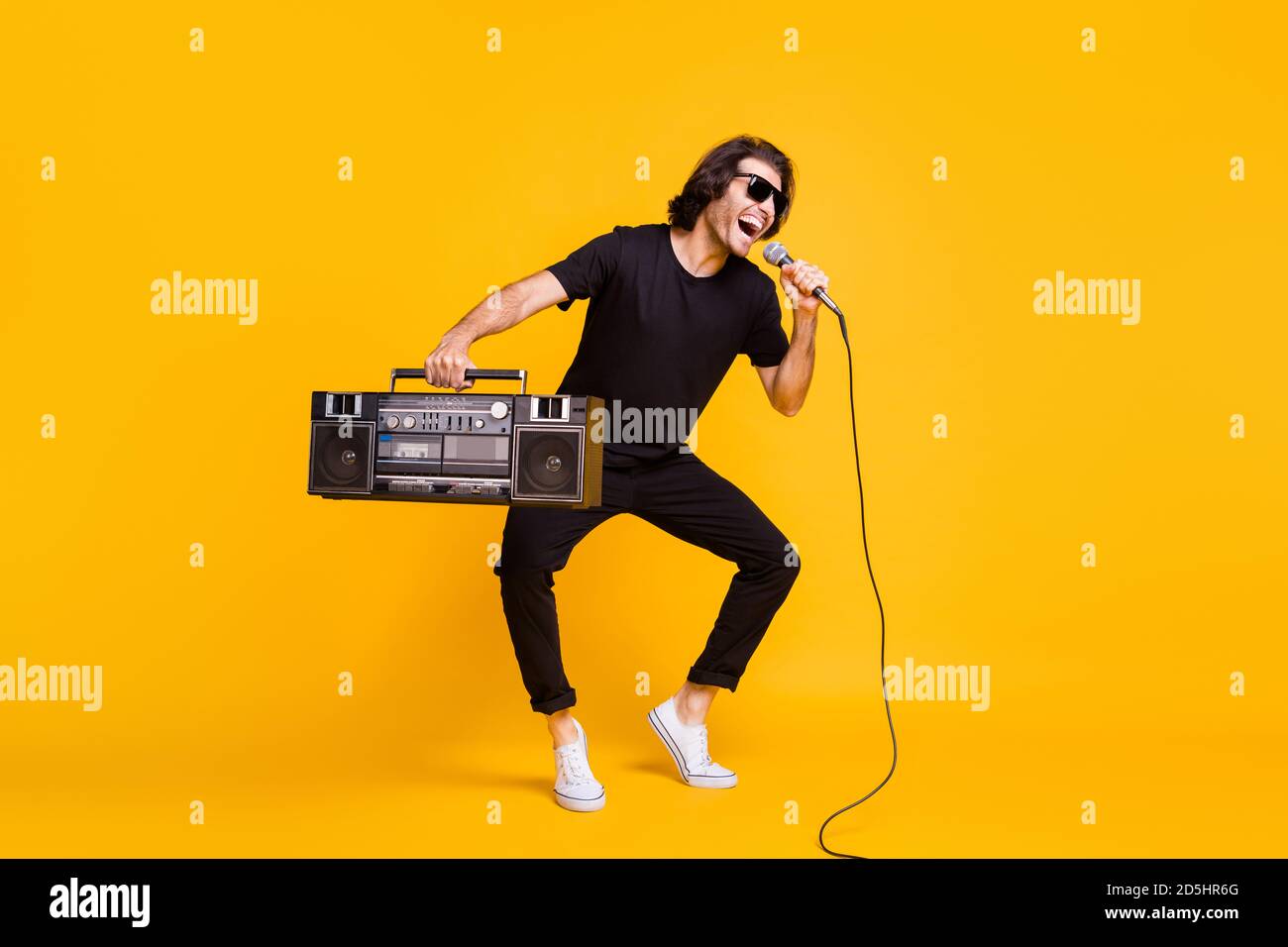 Full length photo of young man hold retro radio mic open mouth wear ...