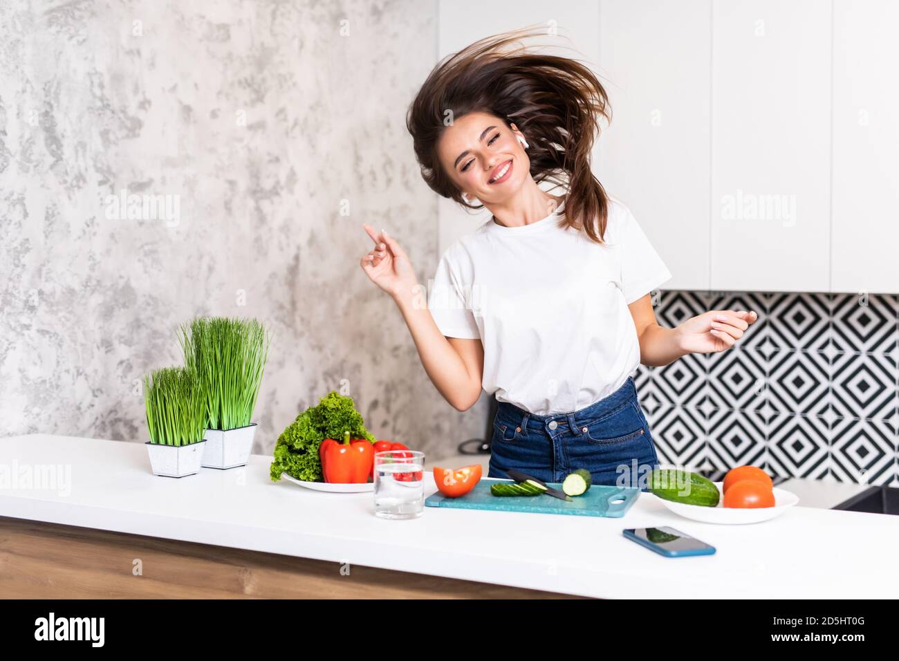 Picture of young amazing emotional woman dancing in kitchen indoors at ...
