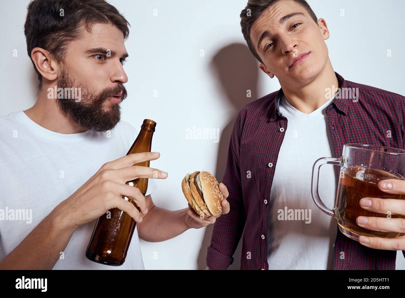 Two friends drink beer leisure fun alcohol friendship lifestyle light ...