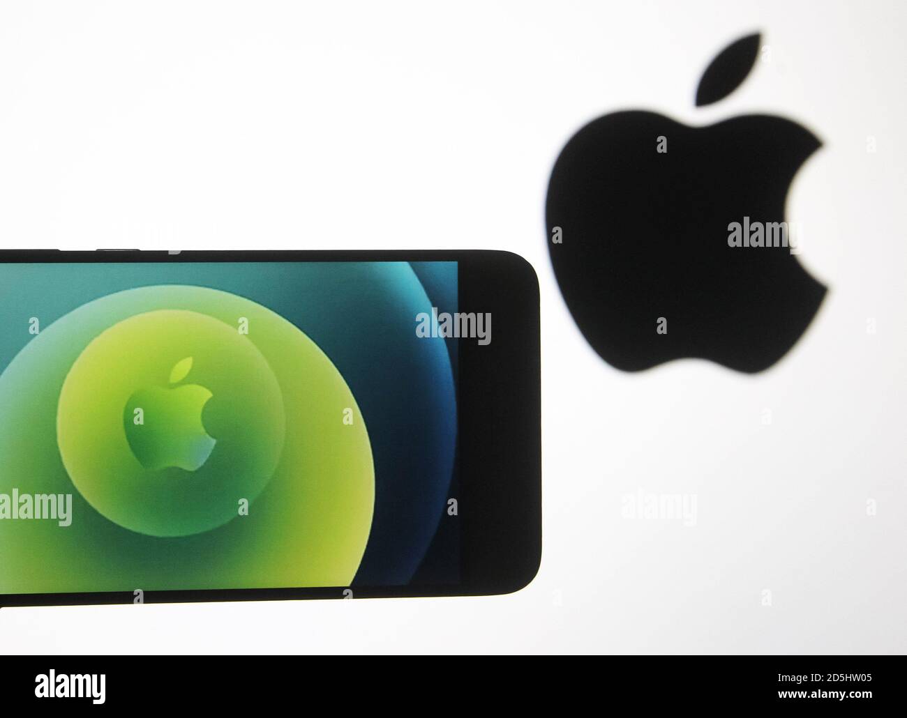 In this photo illustration the Apple logo seen displayed on a ...