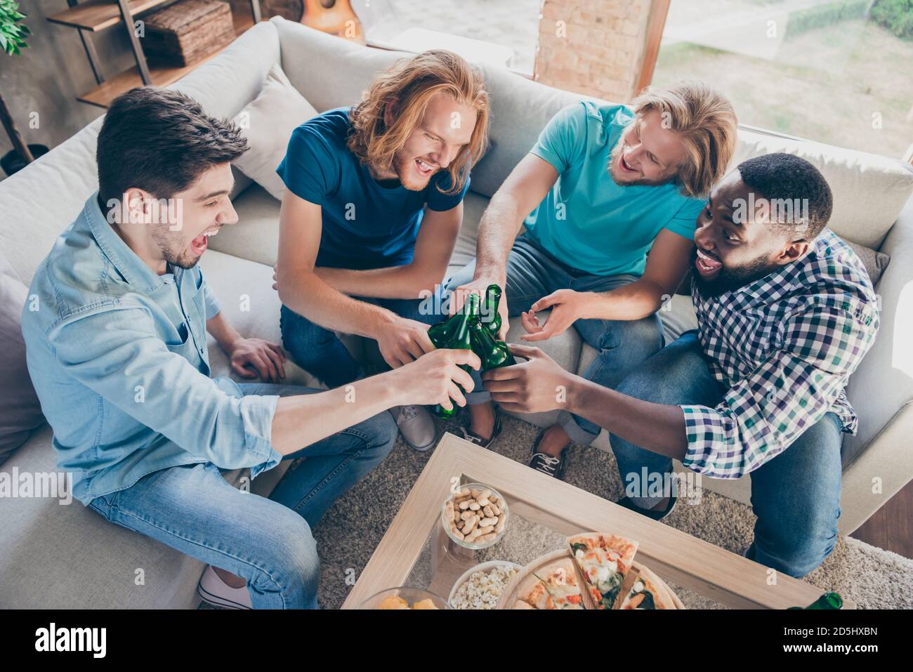 Top above high angle view photo of excited four man pals sit divan ...