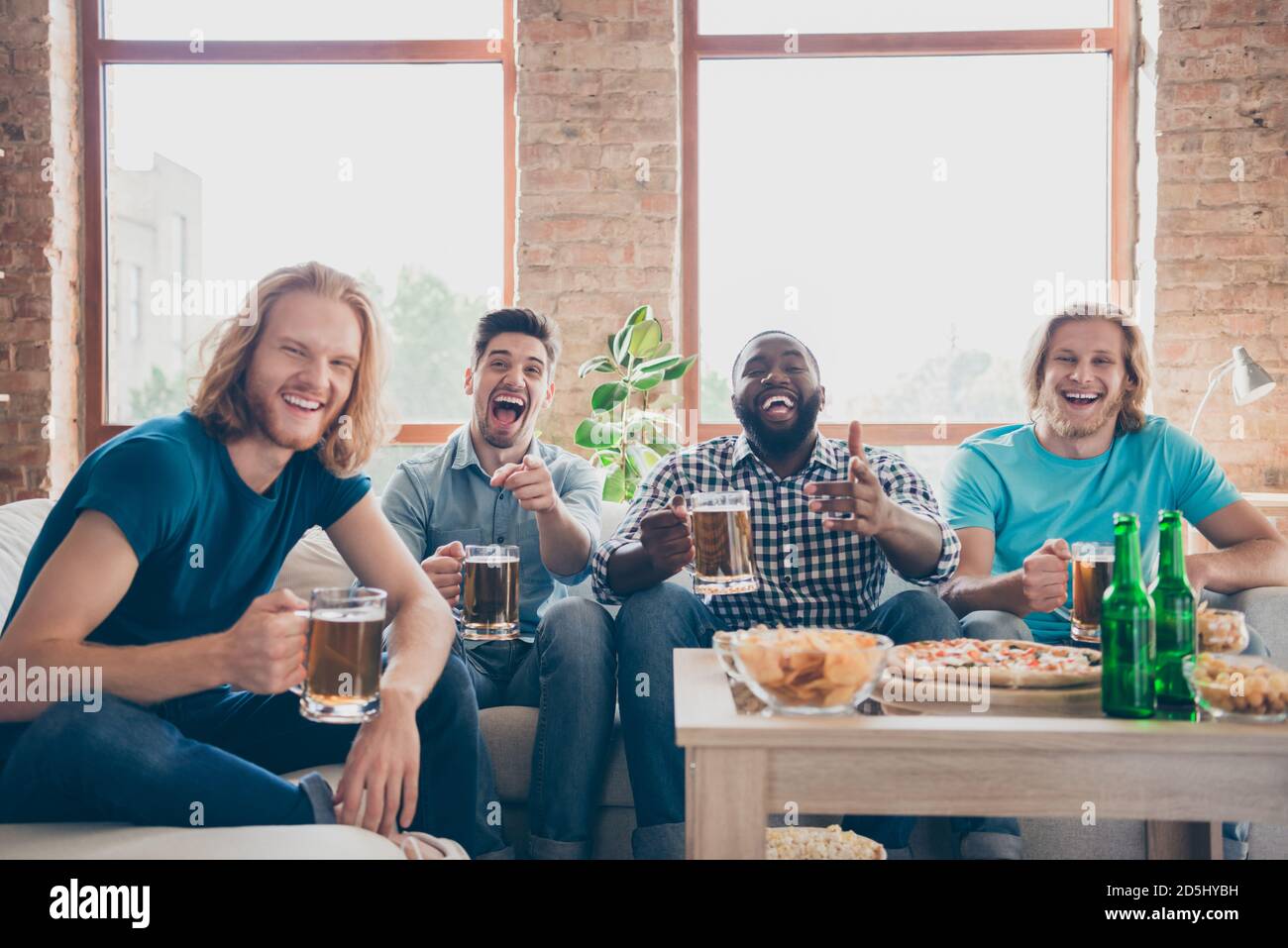 Portrait of crazy four people buddies sit comfort couch watch joke ...