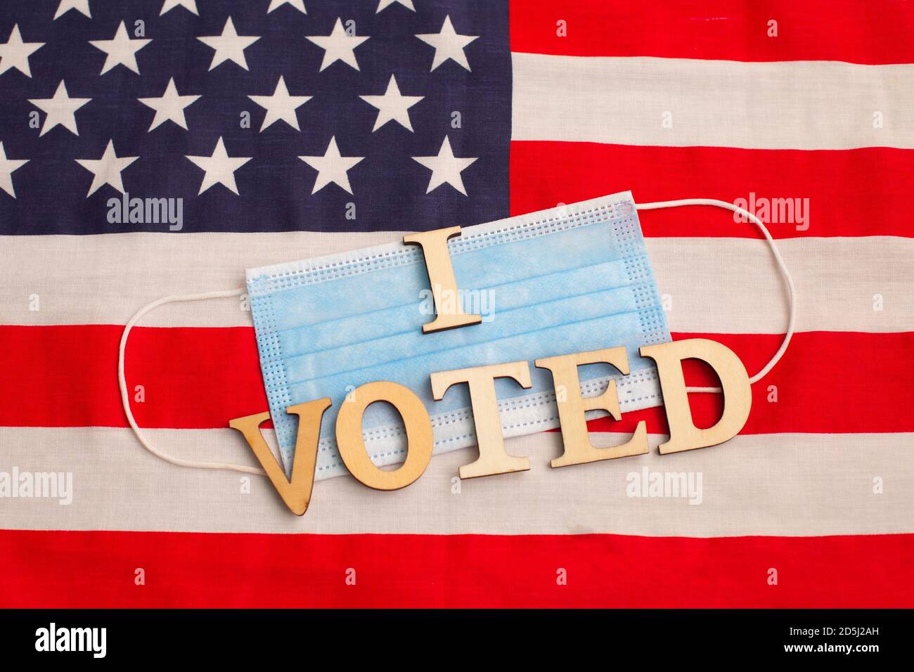 I Voted words on protective face mask on American flag. presidential ...