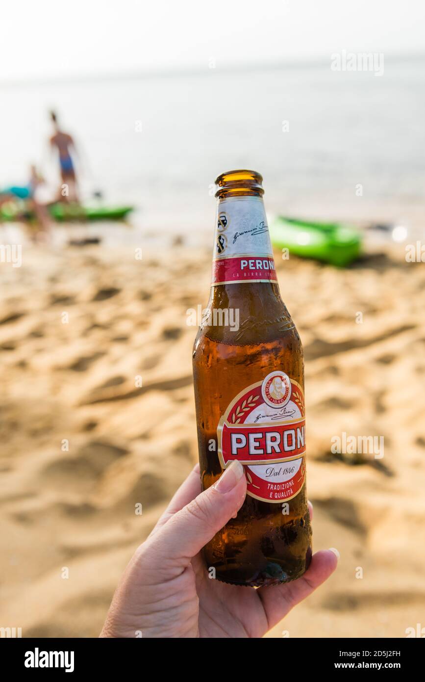 peroni beer in hand at the beach Stock Photo - Alamy