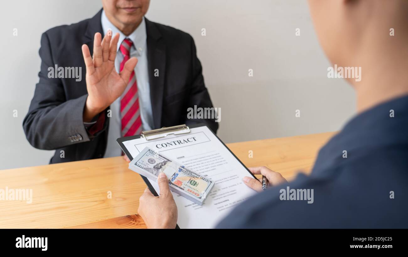 Confident businessman manager rejecting an offer of money to agreement ...