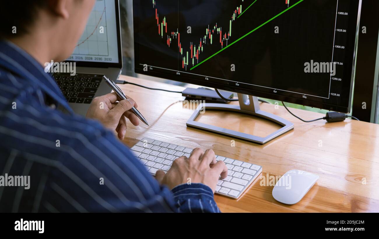 broker showing some ascending to his colleague planning and analyzing ...