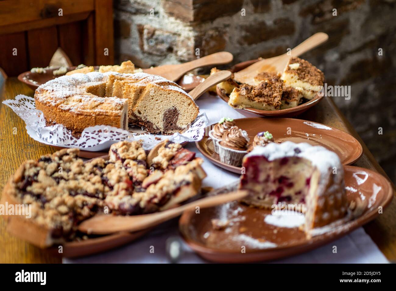 Table full with beautiful and delicious cakes at wedding reception ...
