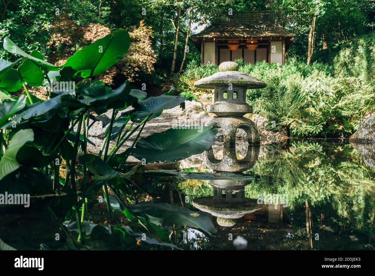 Beautiful shot of a stone statue on a pond in an Asian park Stock Photo ...