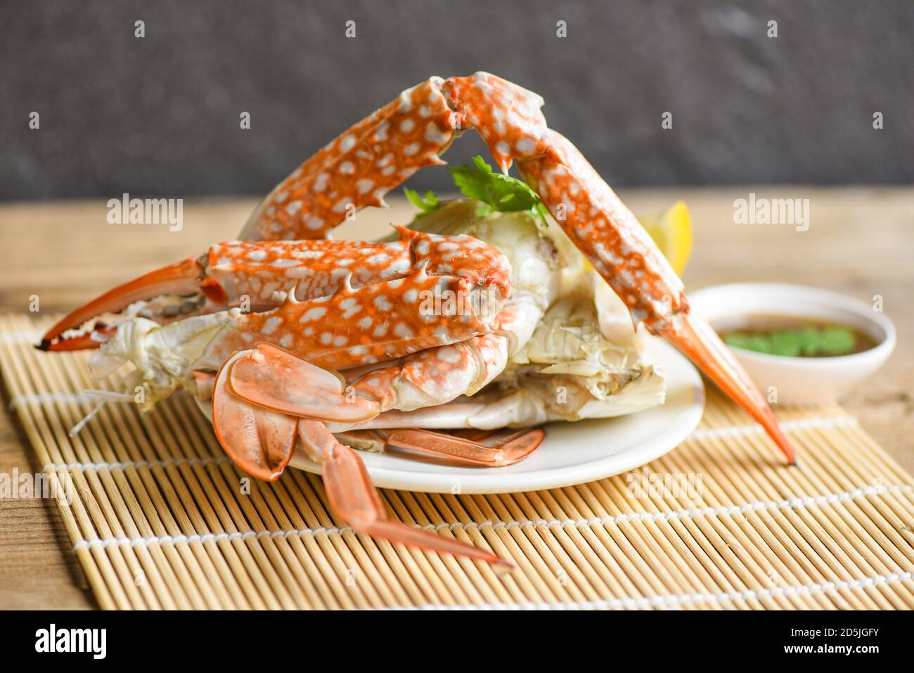 Crab meat / Cooked crab claws and legs on white plate and seafood sauce ...