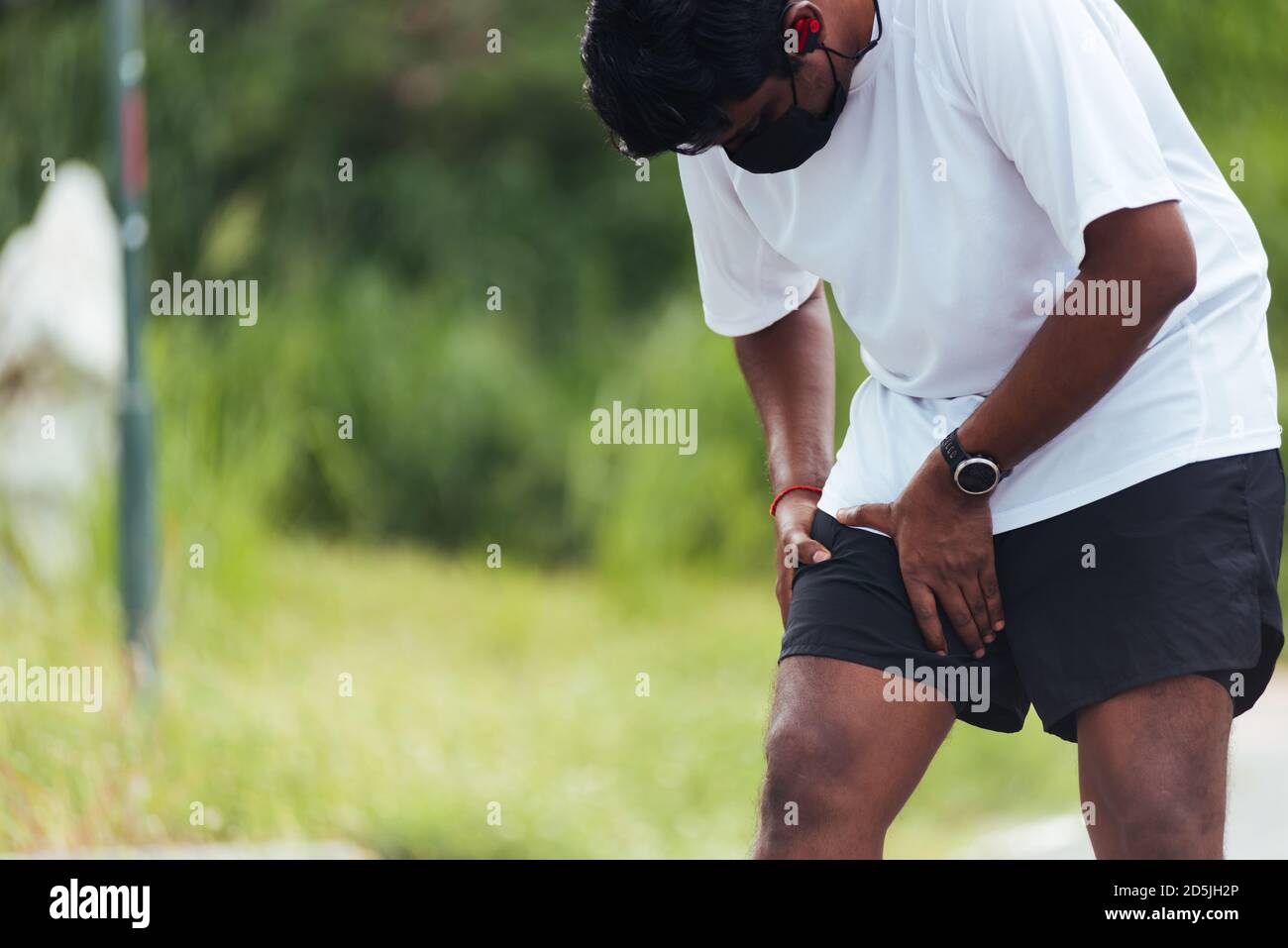 Close up Asian young sport runner black man wear watch hands joint hold ...