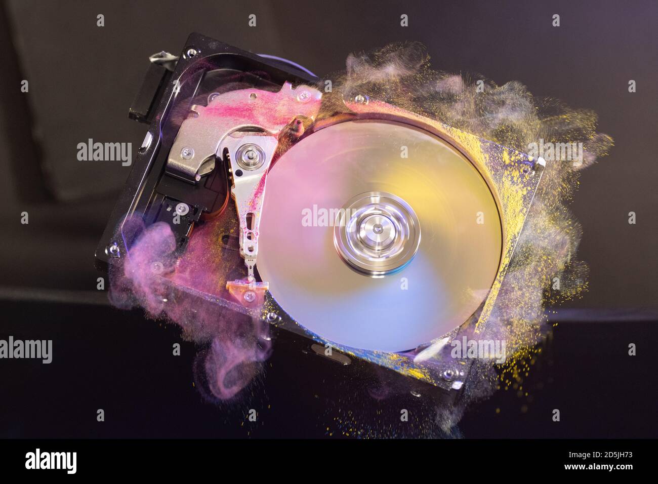 Hard Drive throwing colorful toner dust Stock Photo - Alamy