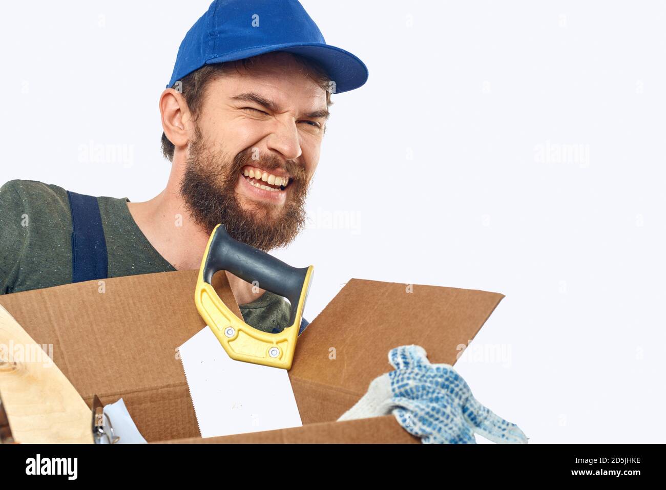 Worker man in uniform with a box in his hands tools delivery service ...