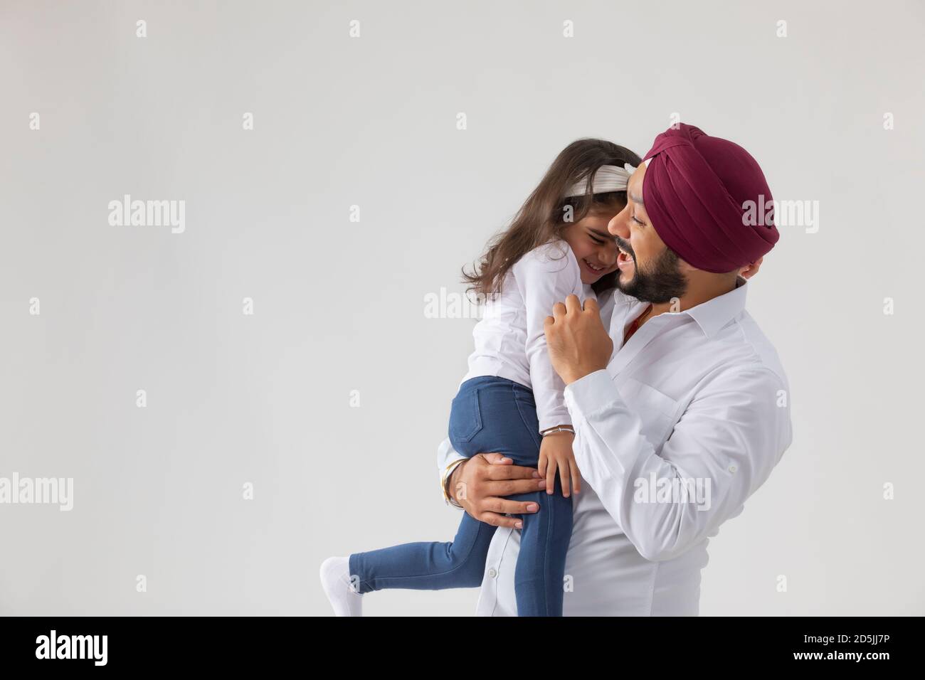 A SIKH FATHER CARRYING HIS DAUGHTER IN ARMS AND ENJOYING FREE TIME ...