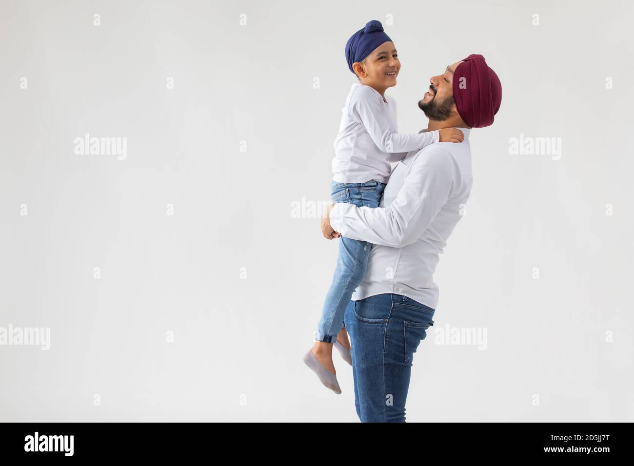 A SIKH FATHER RAISING HIS SON ABOVE AND SPENDING TIME TOGETHER Stock ...