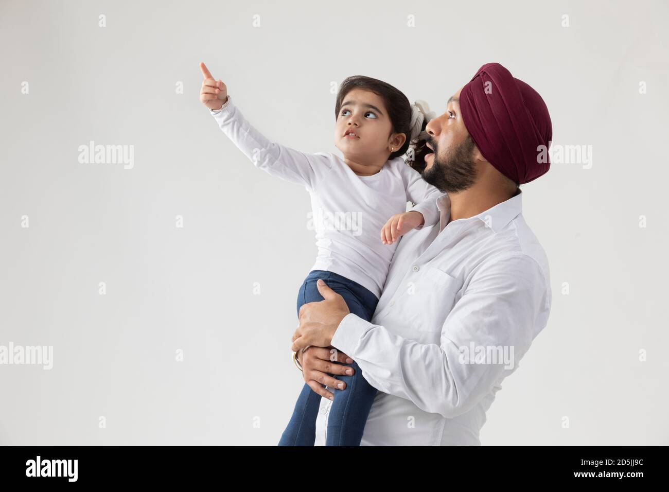 A SIKH DAUGHTER WITH FATHER POINTING TOWARDS A THING ON TOP Stock Photo ...