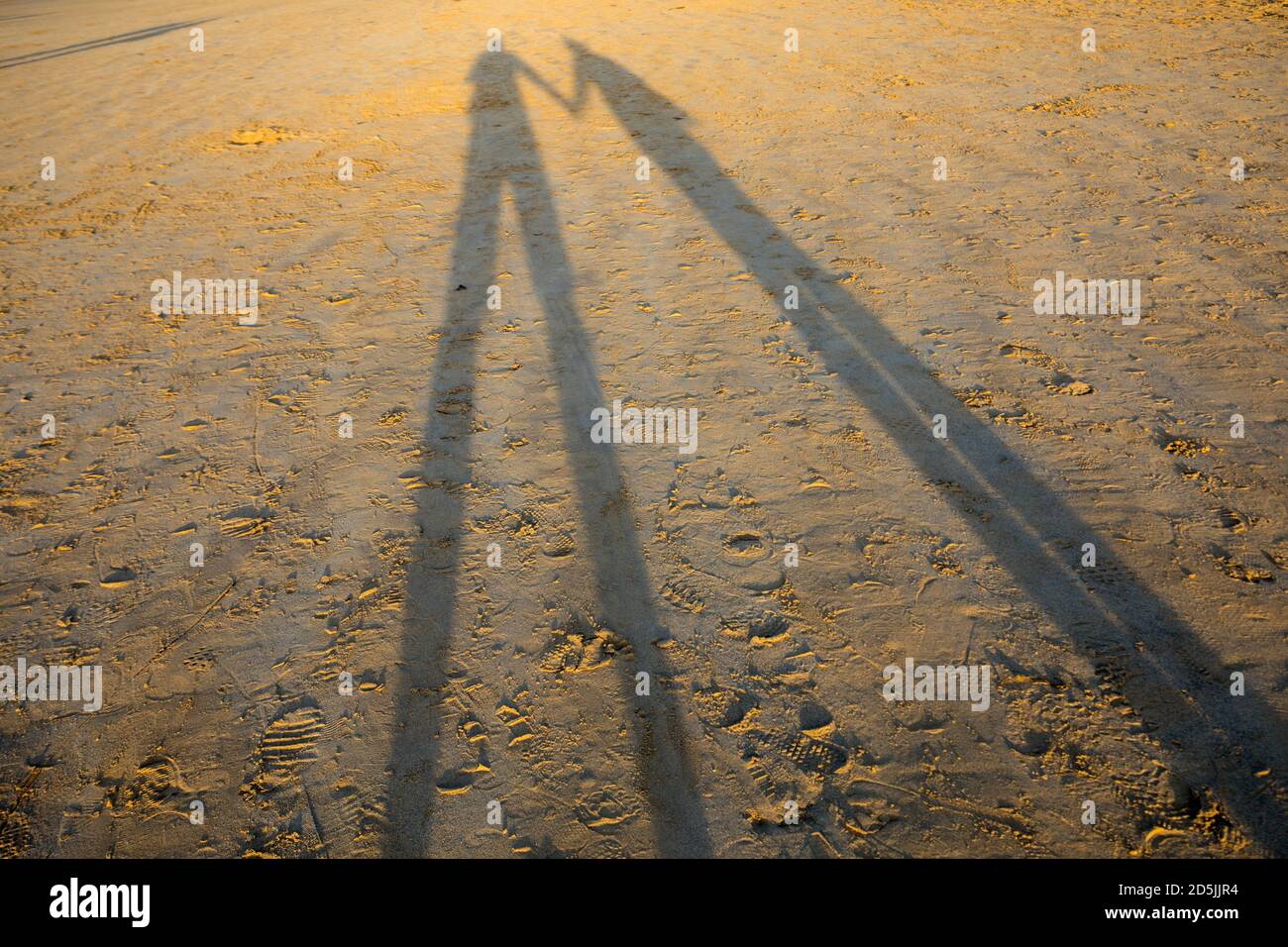 Long shadows of a walking couple on lovely beach in Saint Malo ...