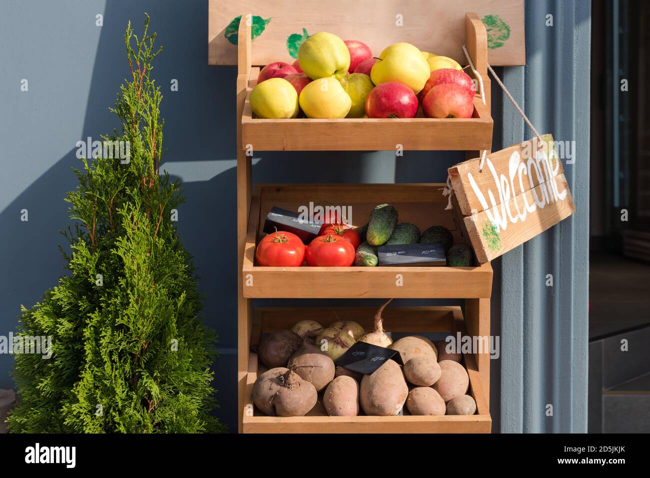Fresh fruits and vegetables on market counter with welcome signboard ...