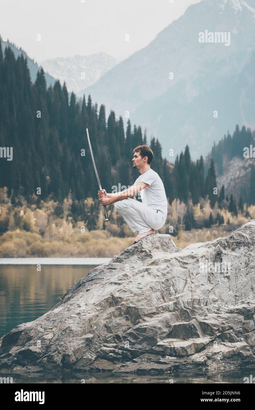 A man with a beard lowered his battle sword. Male defeat Stock Photo ...