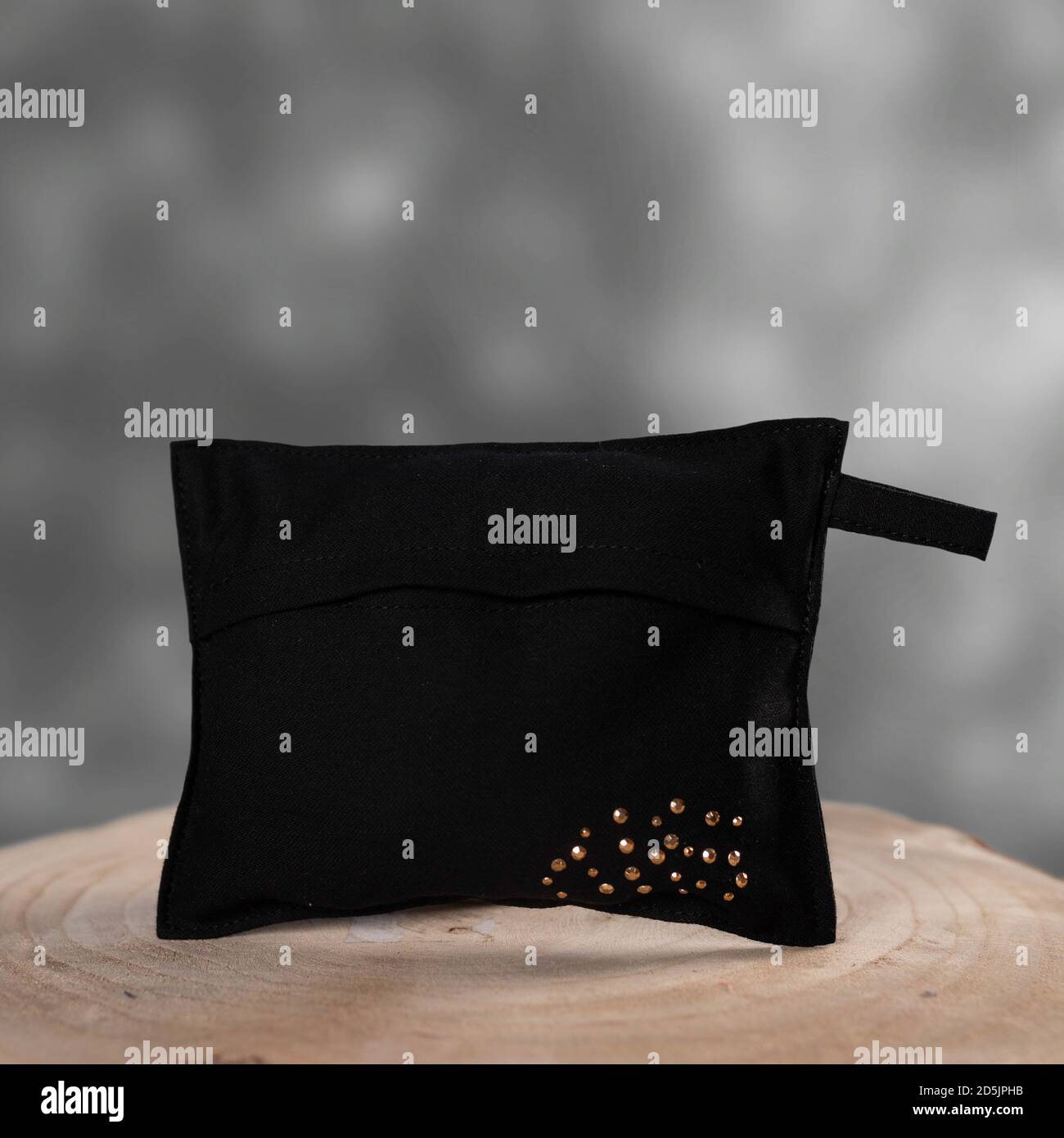 Black hygiene pouch displayed on a wooden disc Stock Photo - Alamy