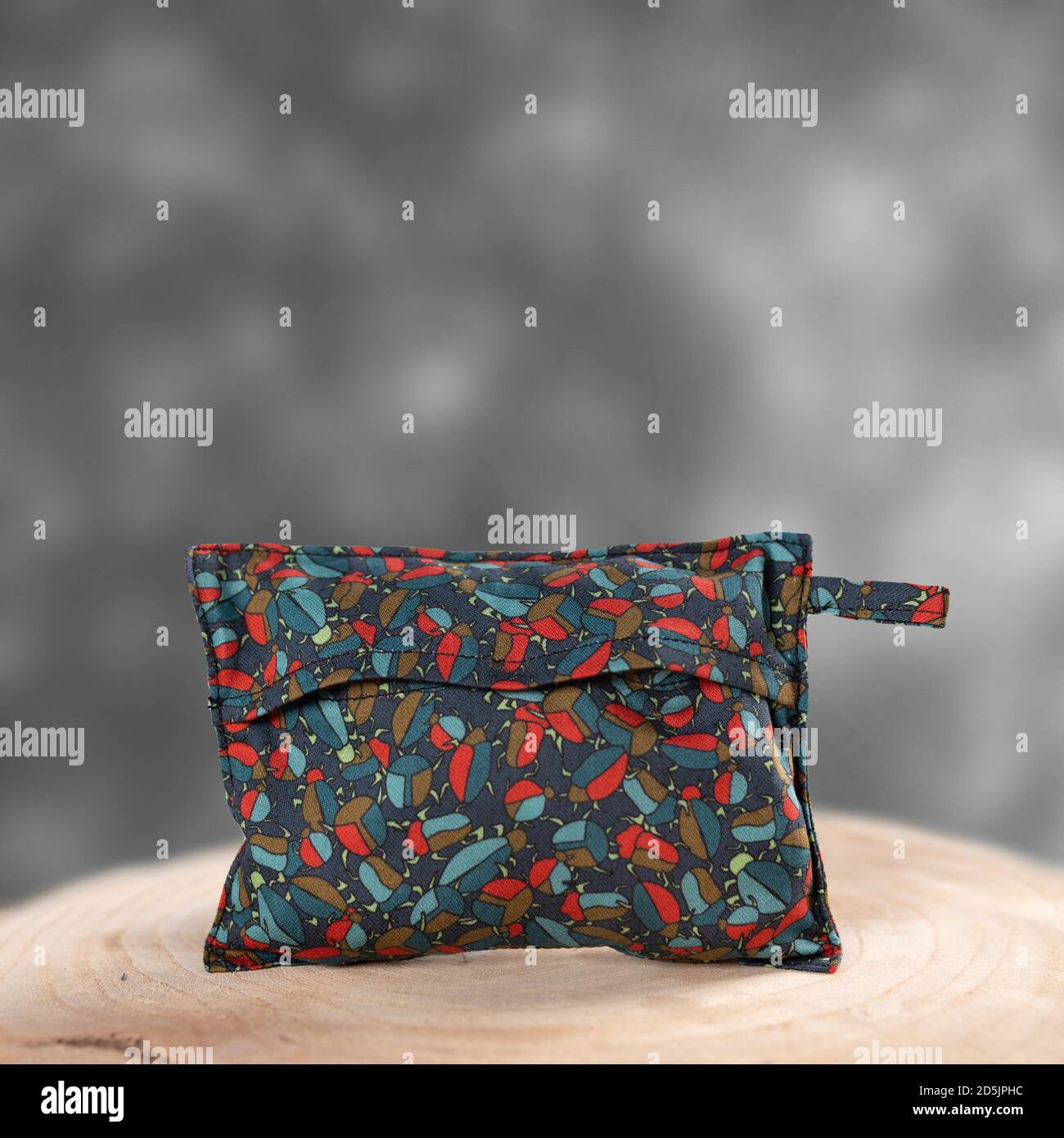Hygiene pouch with colorful print displayed on a wooden disc Stock ...