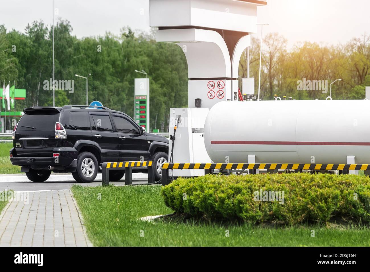 Liquid propane gas station. Black modern SUV car refueling tank with ...
