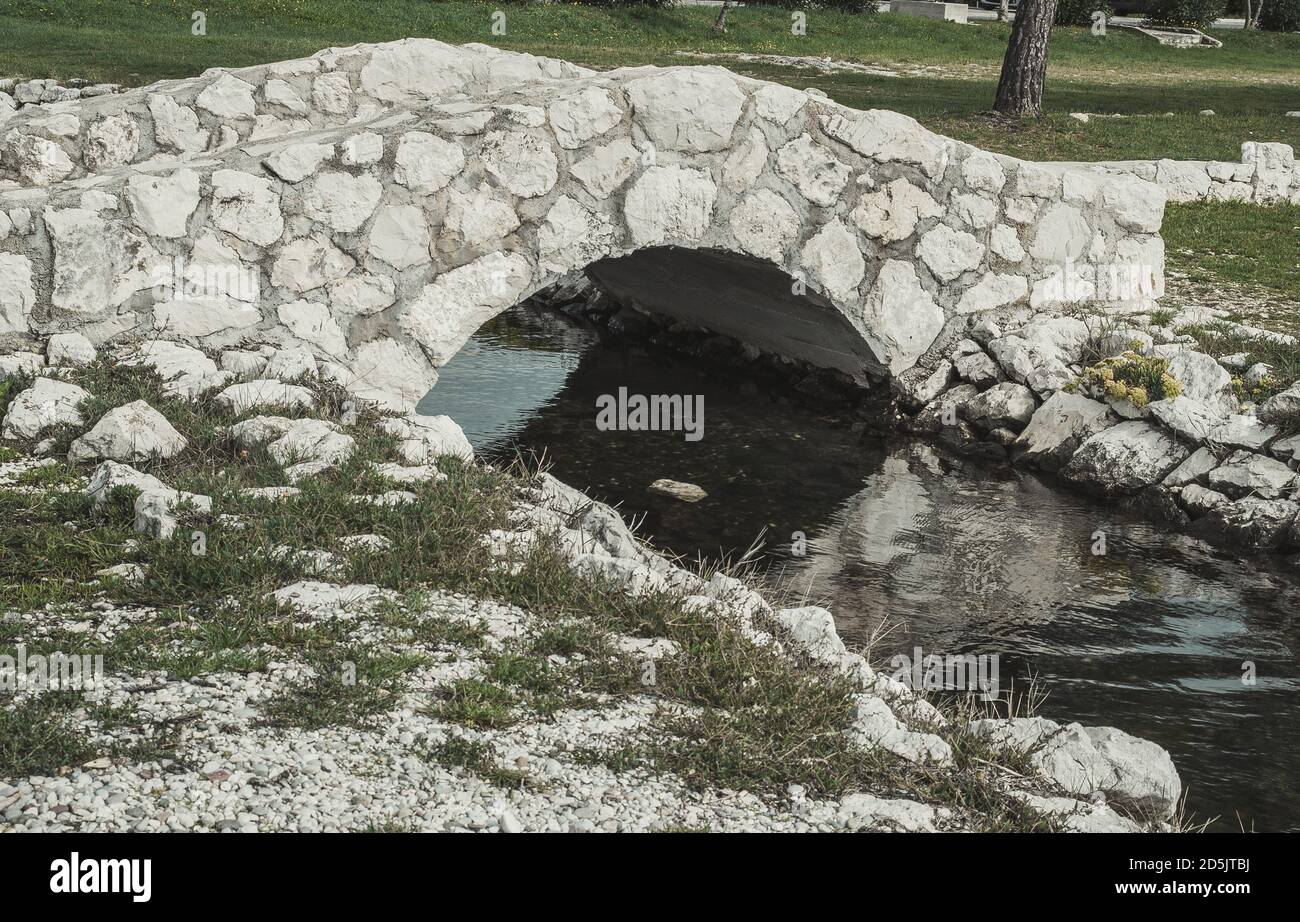 Small stone bridge over a small river Stock Photo - Alamy